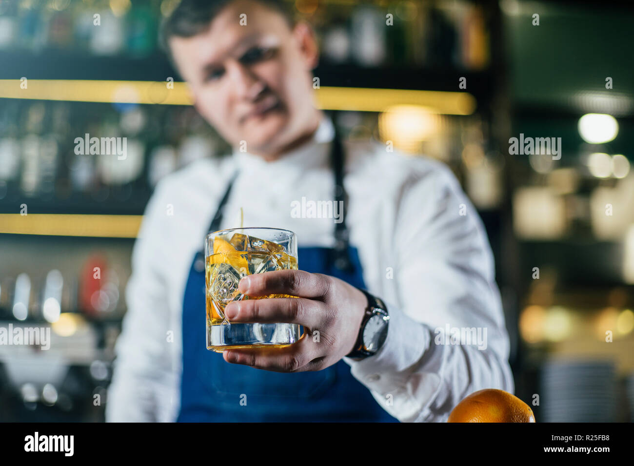 Bartender professionally working with om making drinks and cocktails ...
