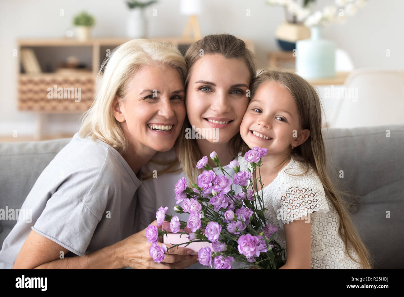 Portrait of happy three generations women family celebrating bir Stock ...