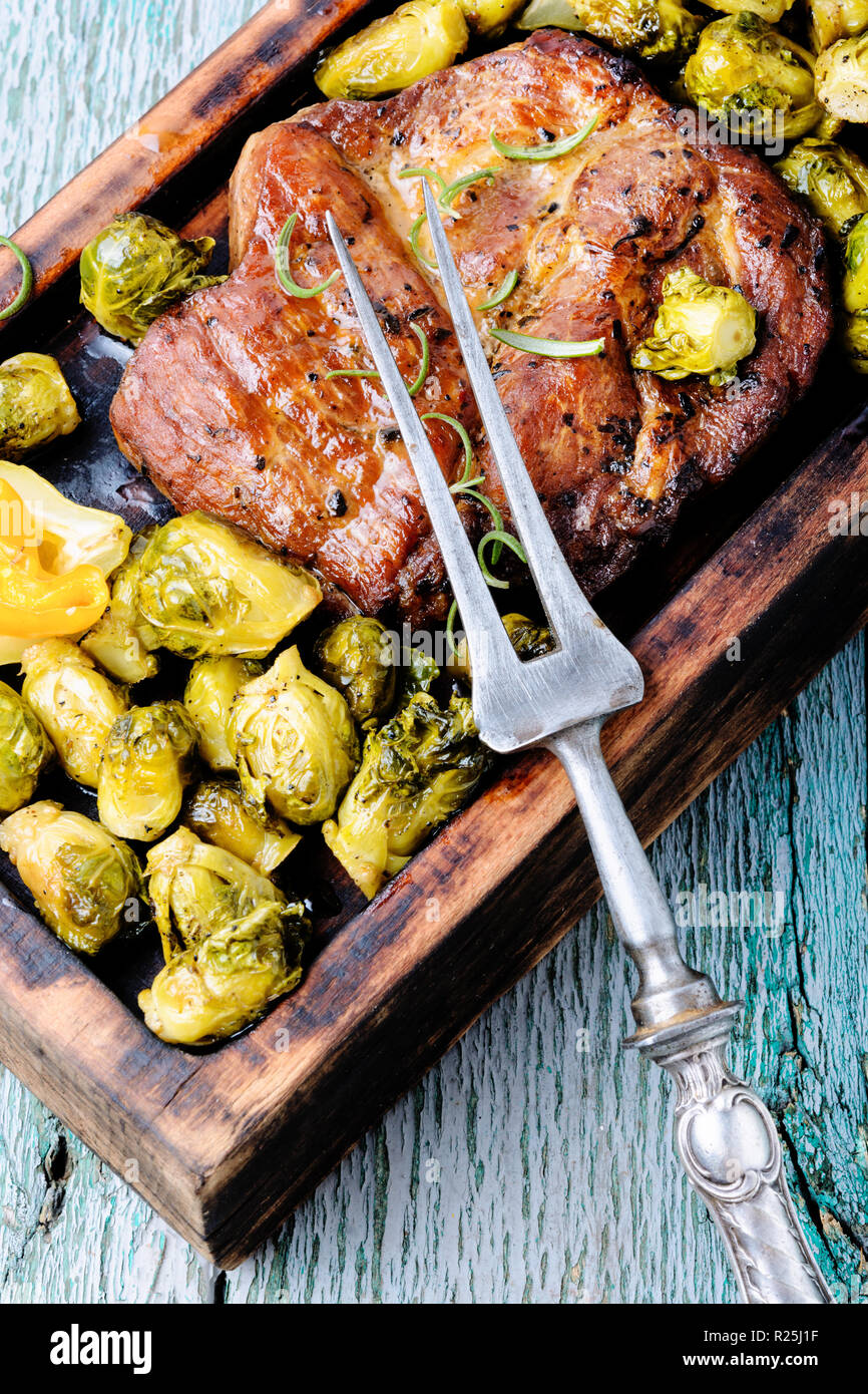 Grilled meat barbecue steak with brussels sprouts Stock Photo - Alamy