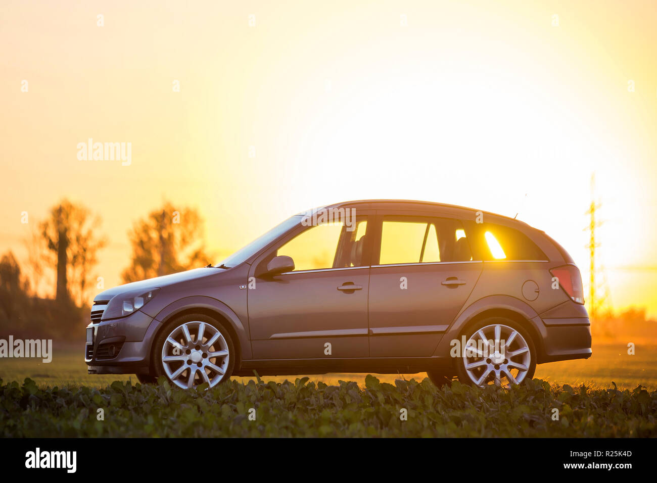Side view of gray silver empty car parked in countryside on blurred ...