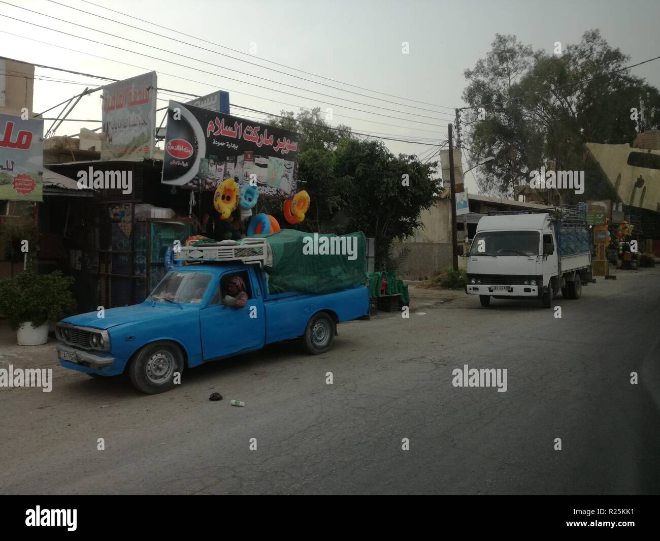 Amman, Jordan - October 18, 2018: A blue pickup truck stands on a dusty ...