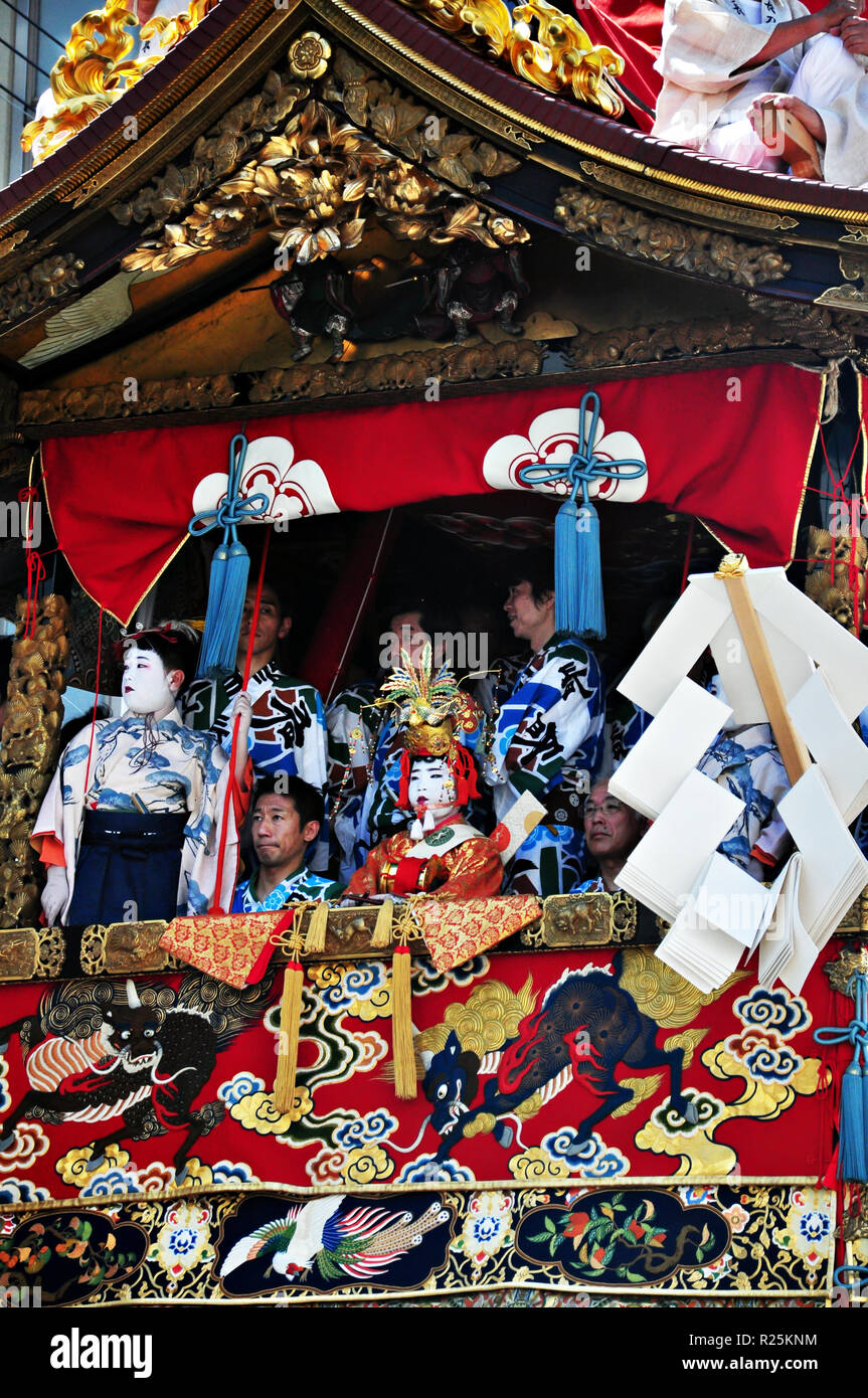 KYOTO, JAPAN: A highly decorated float along with its accompanying men ...