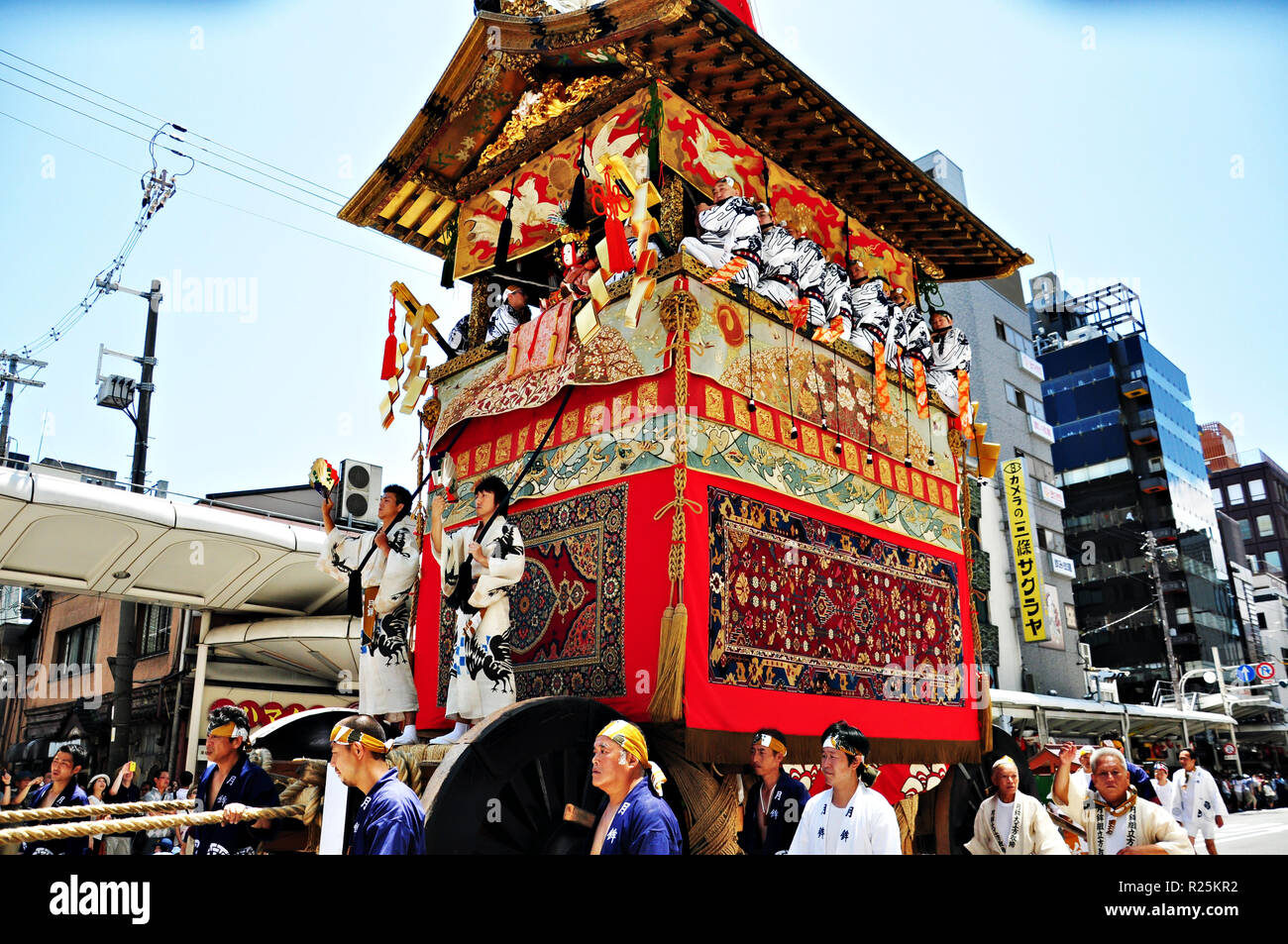 KYOTO, JAPAN: A highly decorated float along with its accompanying men ...