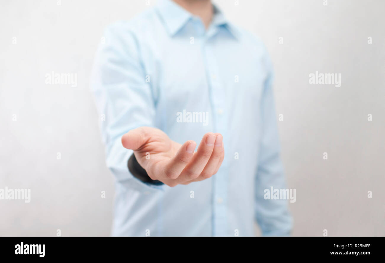 Man with open hand. Holding, giving, showing concept Stock Photo - Alamy