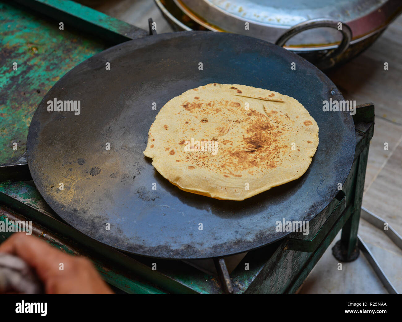 Cooking Tandoori naan or Roti at local restaurant in Jodhpur, India ...