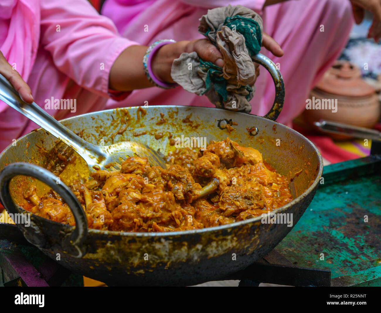 Indian woman cooking chicken curry at local restaurant Stock Photo - Alamy