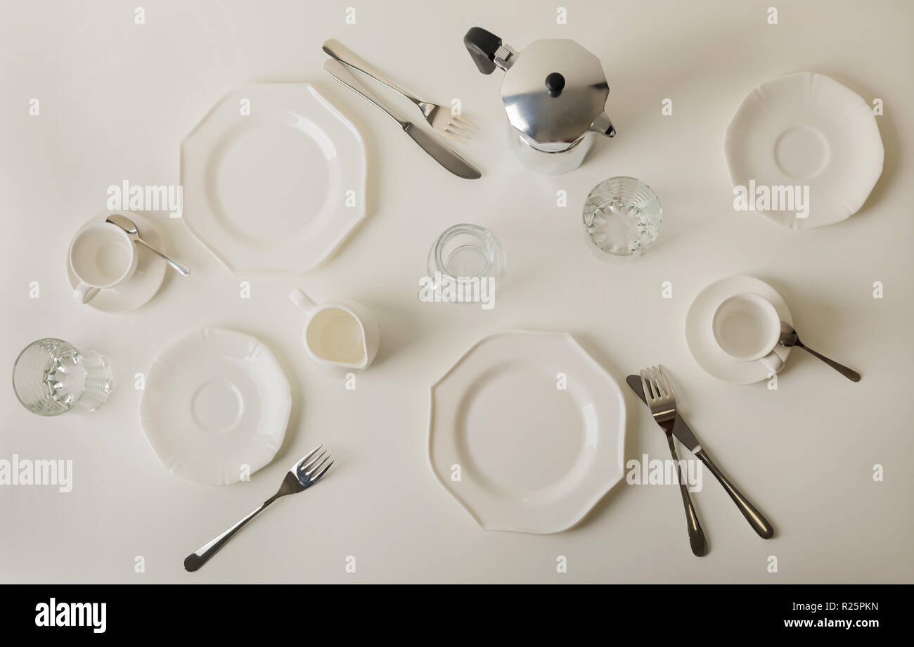 Breakfast time. Table setting for brearfast. Crockery, plates, cups and ...