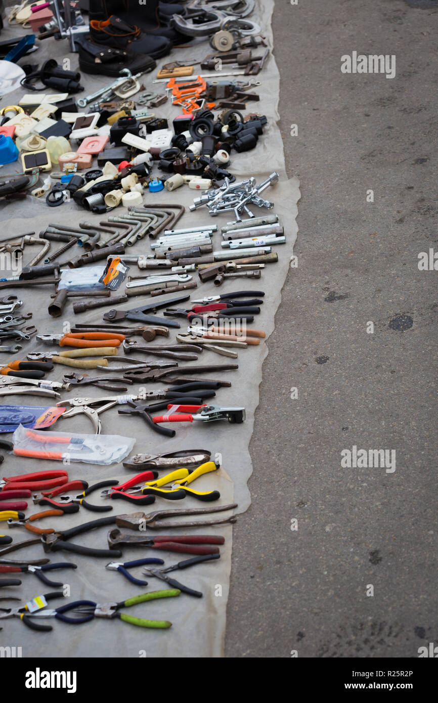 Old metal wrench, key, pliers lying on the asphalts at flea market in ...