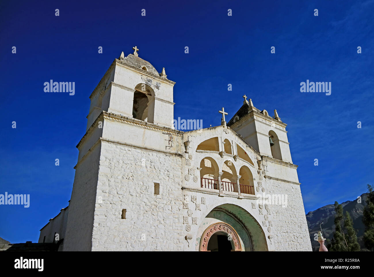 Church of Santa Ana de Maca against vivid blue sky, Colca canyon ...