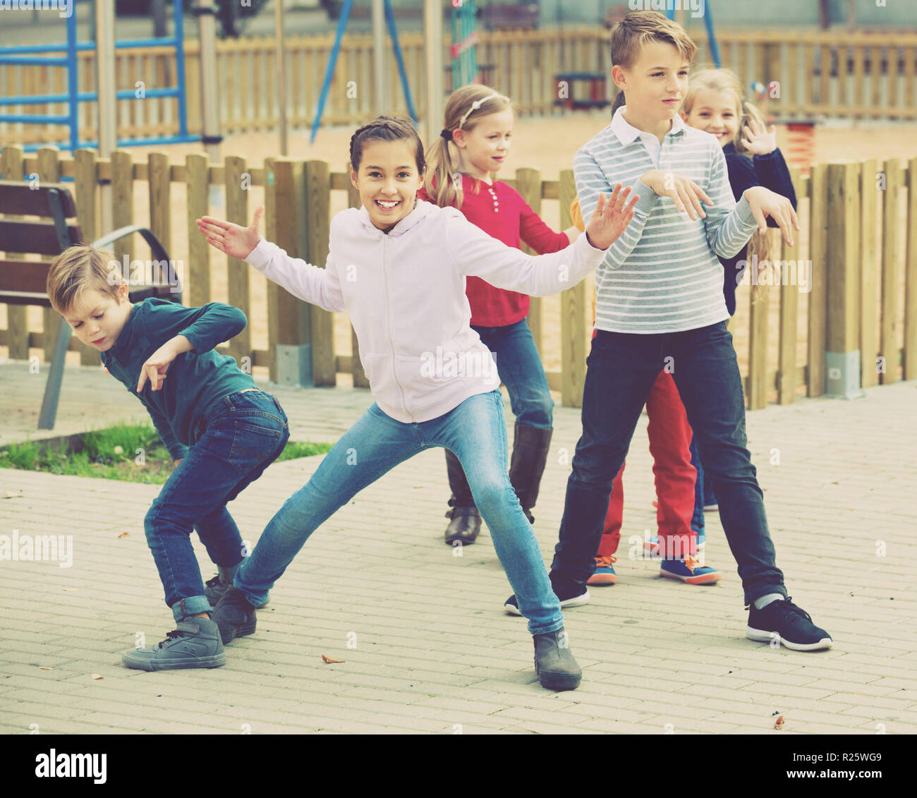 Acting game with happy cheerful children making performance outdoor in ...