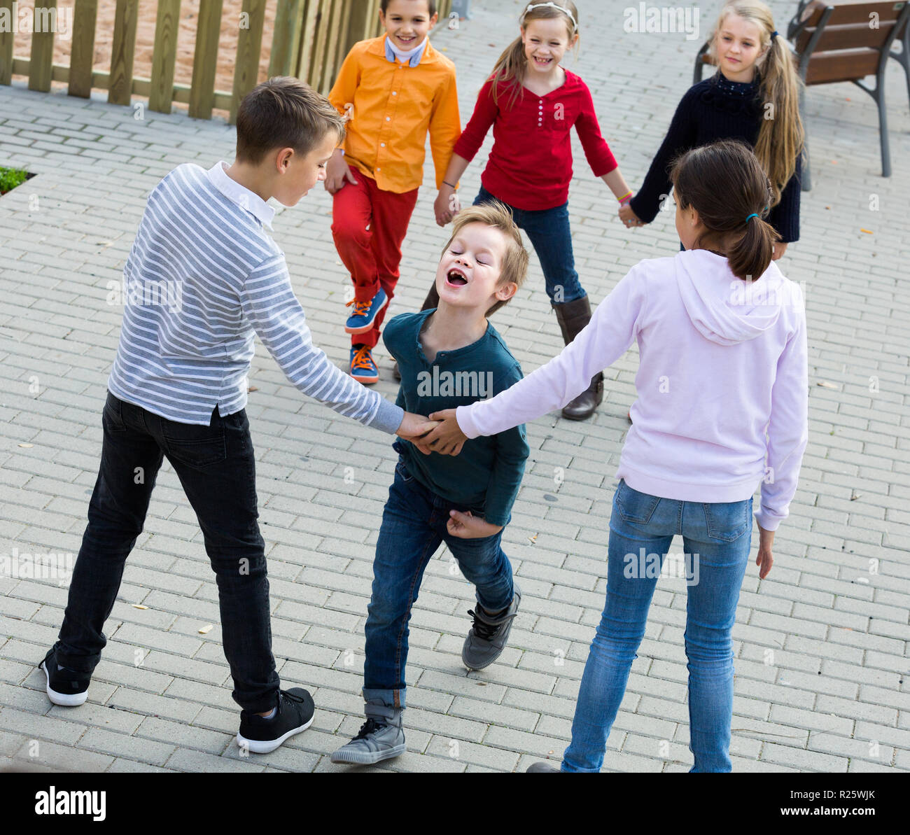 Group of smiling glad children playing red rover outdoors Stock Photo ...