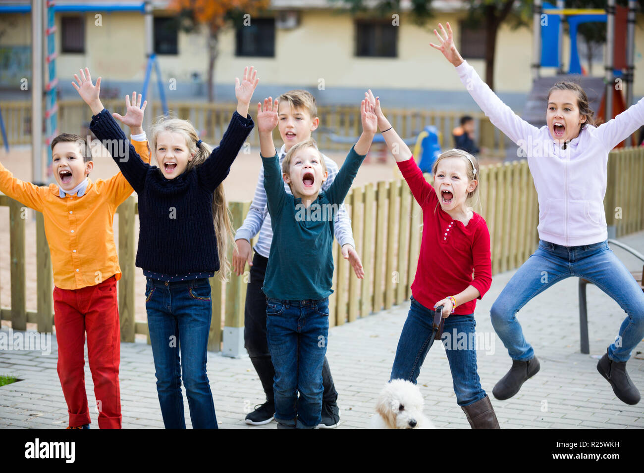 Group of happy kids in high spirits jumping outdoors Stock Photo - Alamy