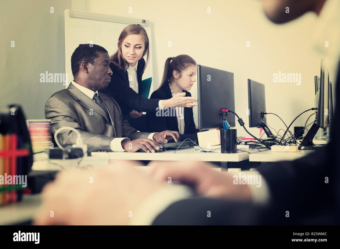 Successful diligent efficient positive coworkers engaged in business activities in busy open ...