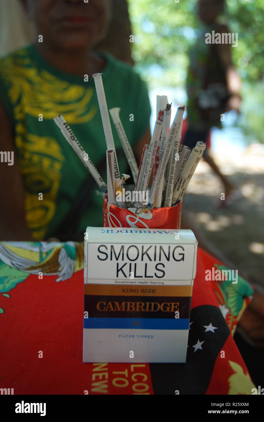 Woman selling handmade cigarettes at market in Madang, Papua New Guinea ...