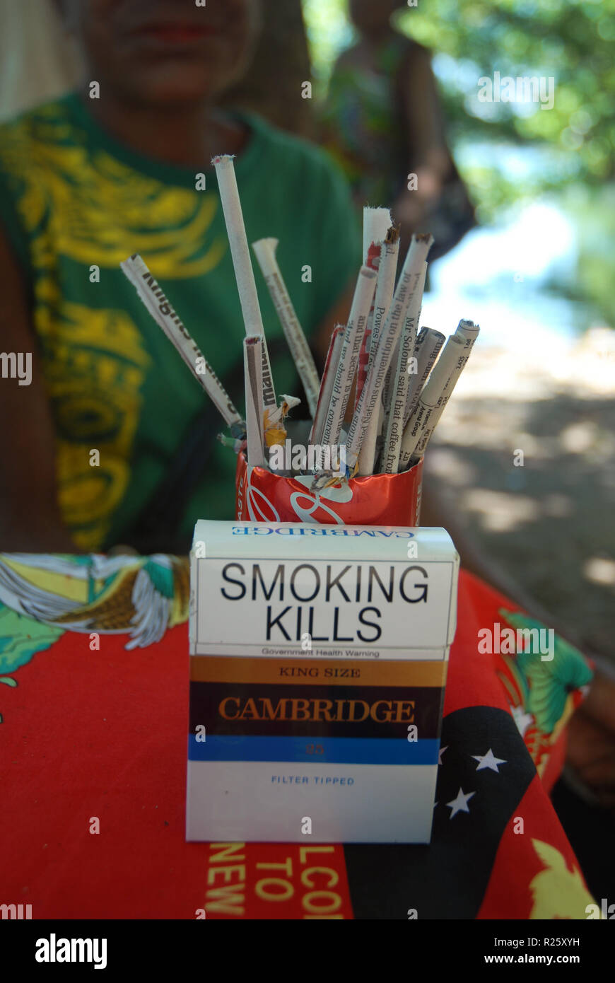 Woman selling handmade cigarettes at market in Madang, Papua New Guinea ...