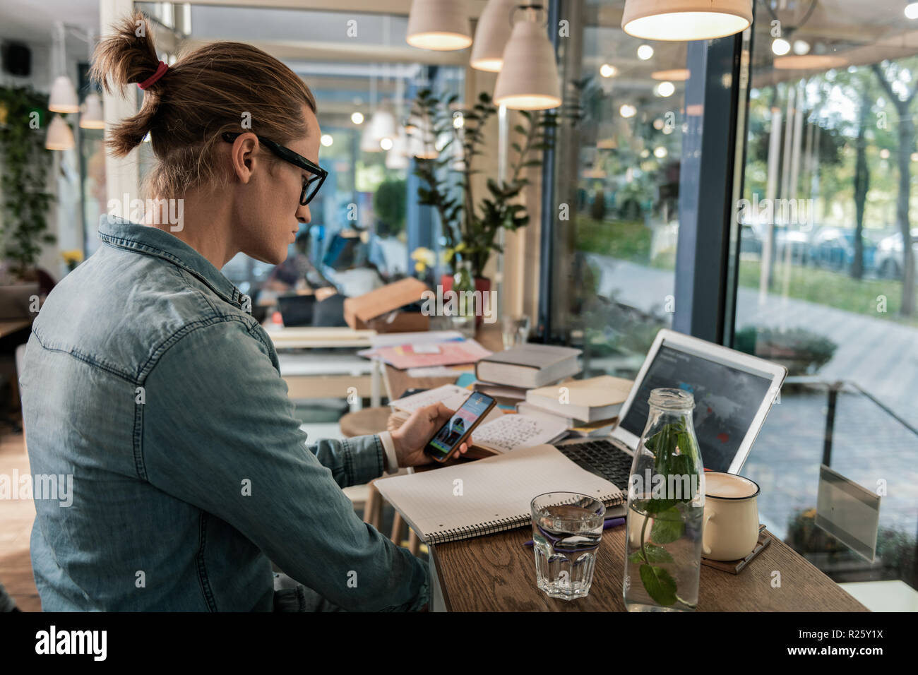 Smart young man holding a smartphone in his hands Stock Photo - Alamy