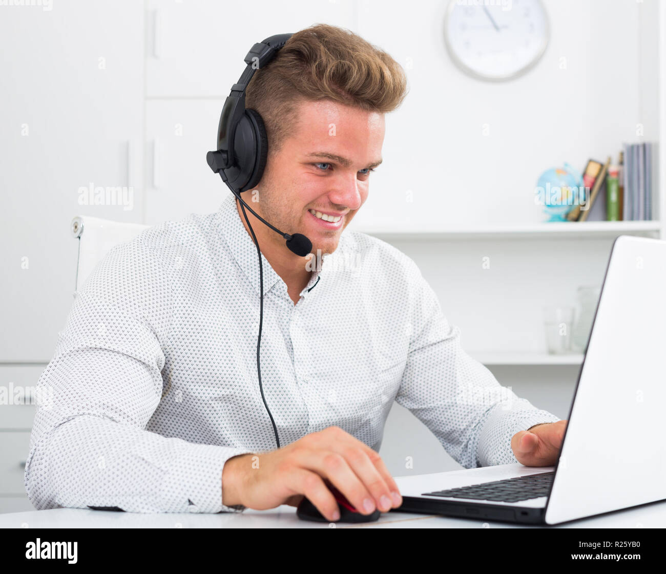 Positive call center male operator talking with client in agency Stock ...