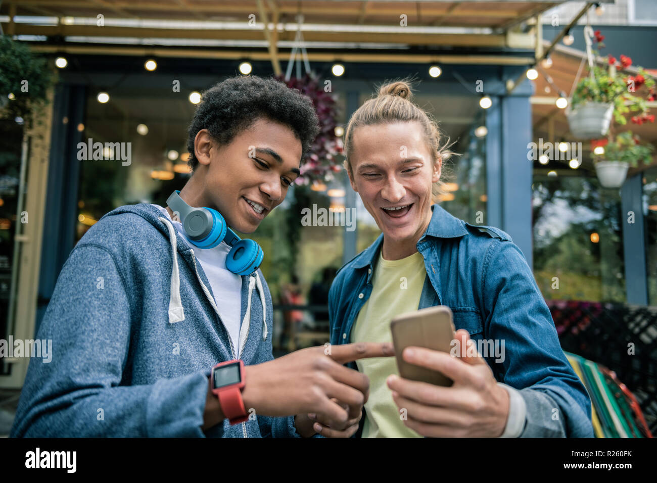 Cheerful happy man pointing at the smartphone screen Stock Photo - Alamy