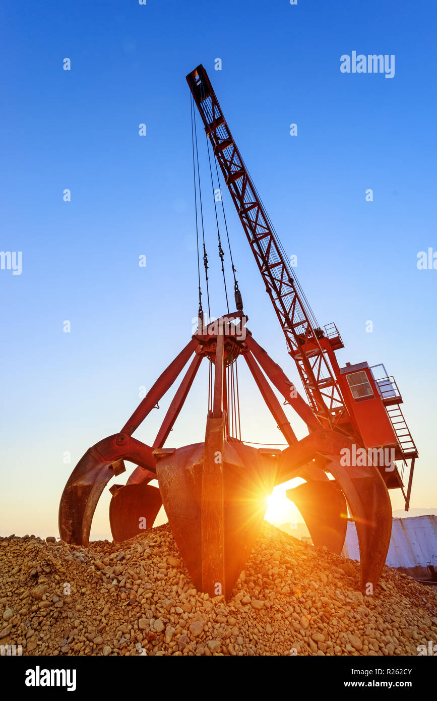 Backhoe digger unloading sand hi-res stock photography and images - Alamy