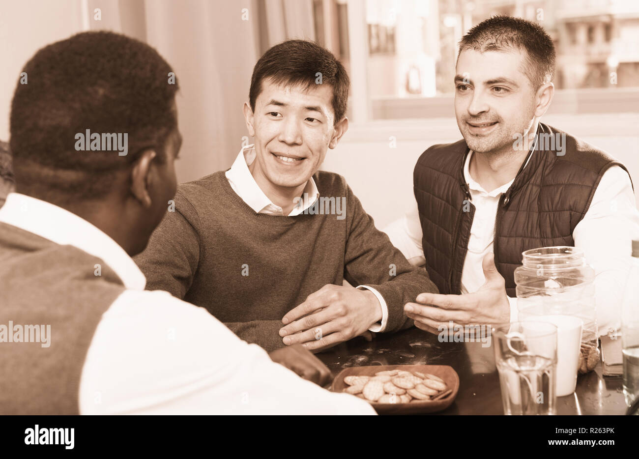 Three friends are talking about life together at home Stock Photo - Alamy