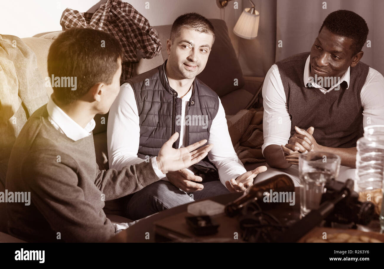 Three men are drinking beer and talking about life in time rest ...