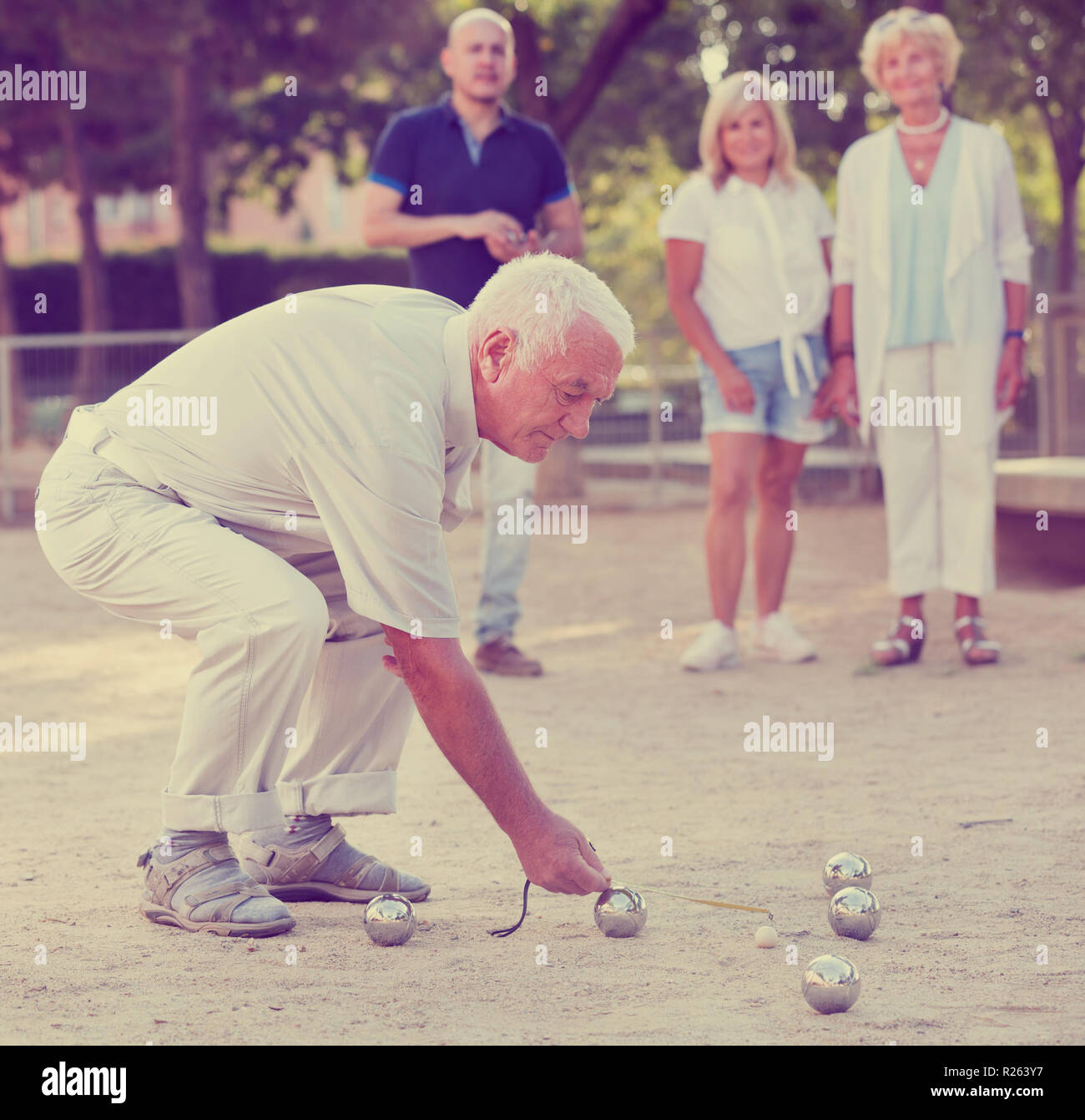 Happy family of two generations playing bocce in a garden Stock Photo ...