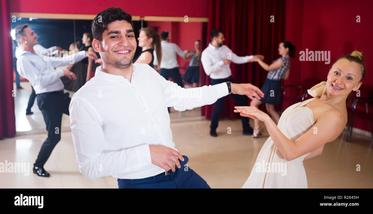 Adult dancing couples enjoying active dance in modern studio Stock ...