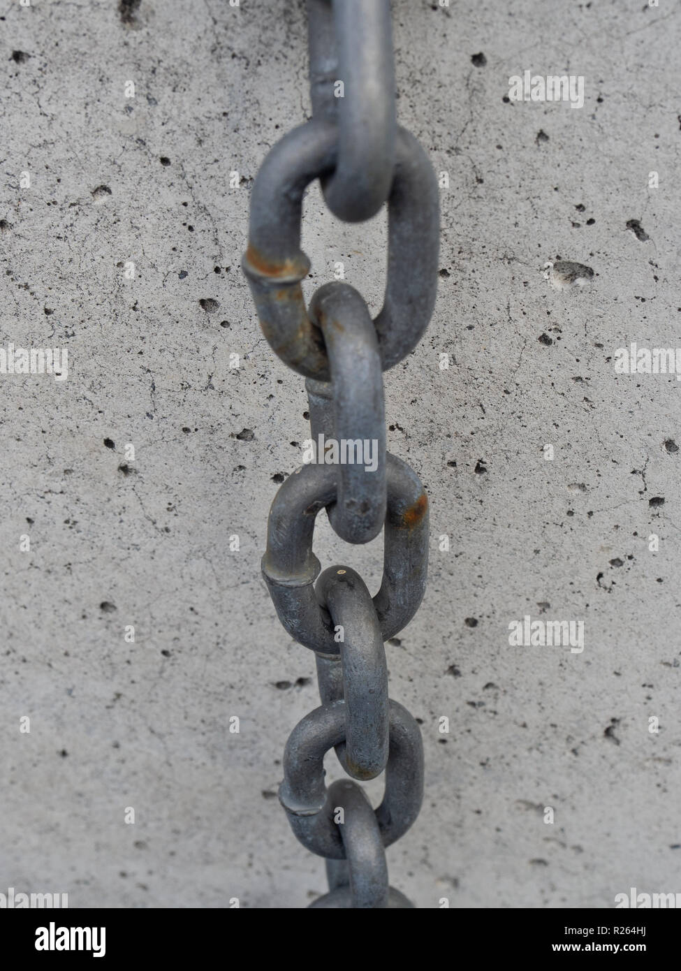 Metal Chain Against A Concrete Wall Stock Photo - Alamy