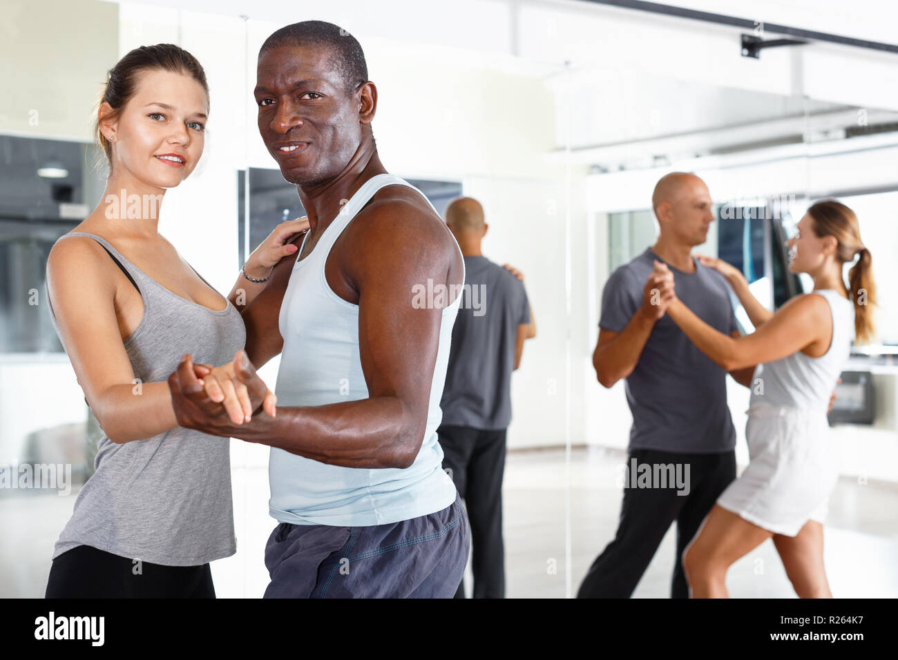 Young happy smiling positive people dancing together slow ballroom ...