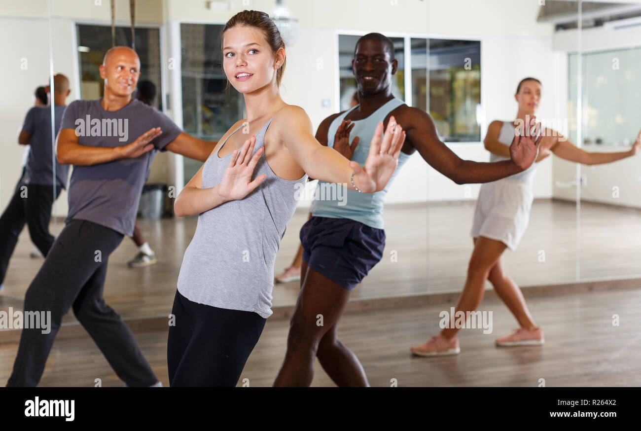glad young dancing people practicing vigorous swing in dance studio ...