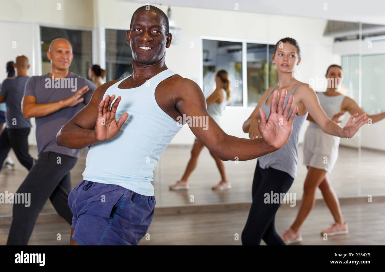 Group of multinational happy people dancing together in modern studio ...