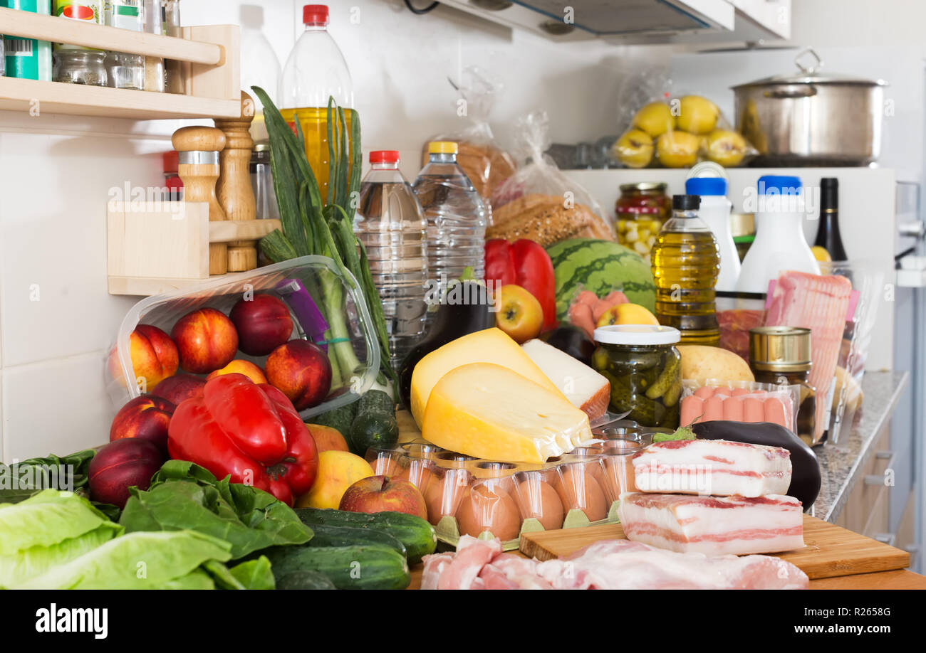Image of full table of different food in the kitchen in home interior ...