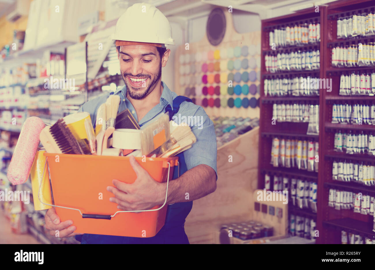 Happy cheerful positive smiling workman holding basket with picked ...