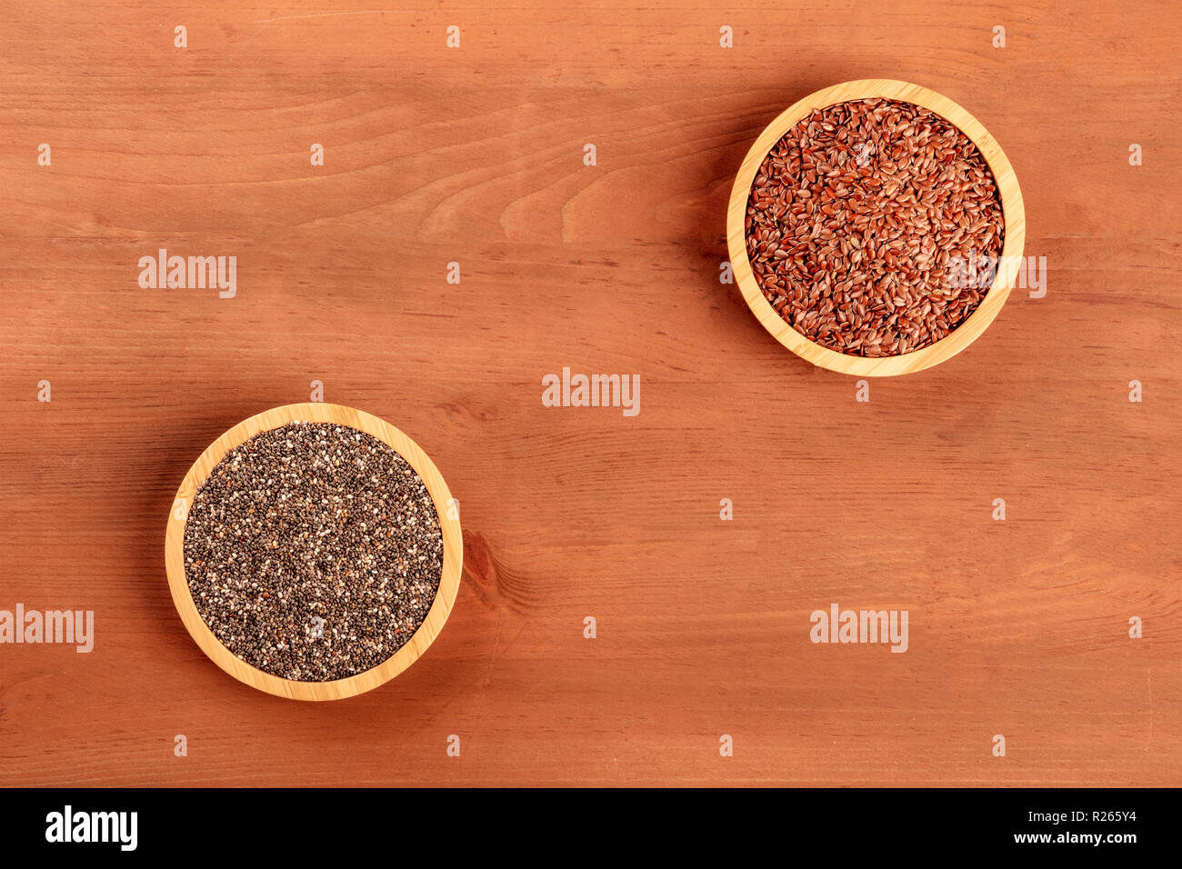 A photo of chia seeds and flaxseeds, shot from above on a rustic ...