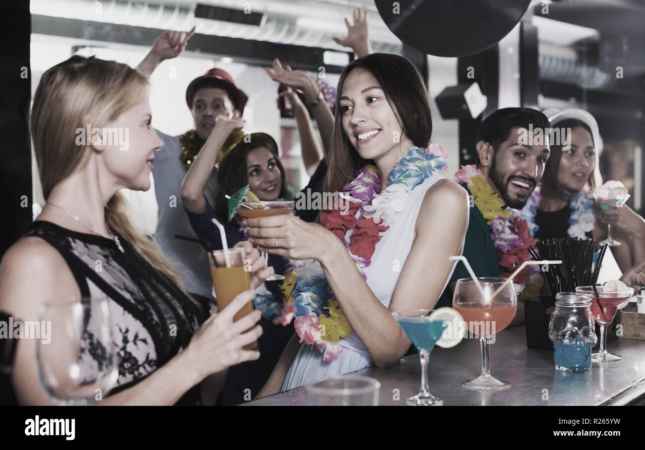 Women are drinking cocktails on hawaiian party in bar Stock Photo - Alamy