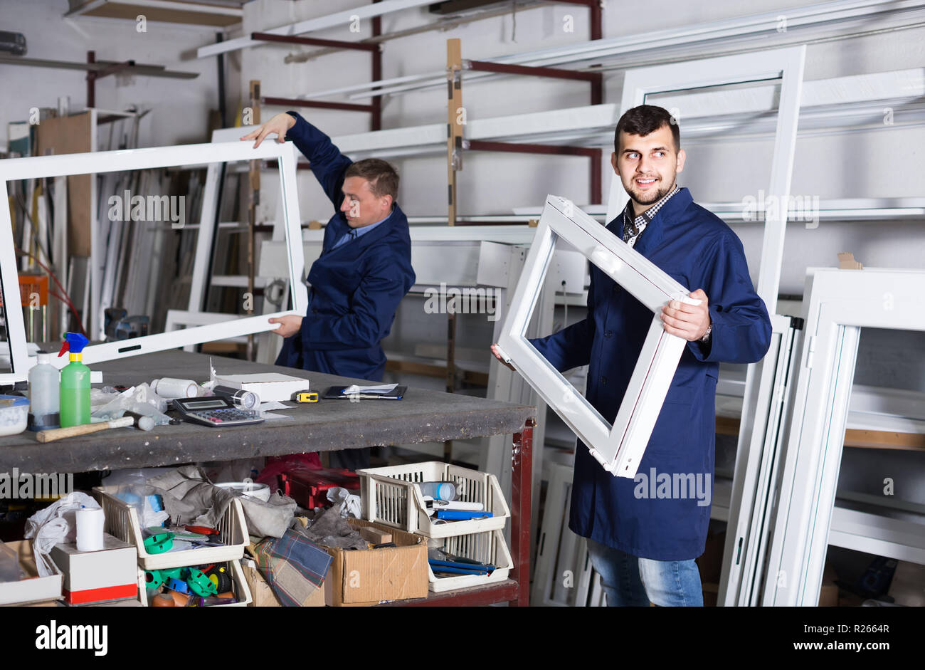 Production happy spanish workers in coverall with different finished ...