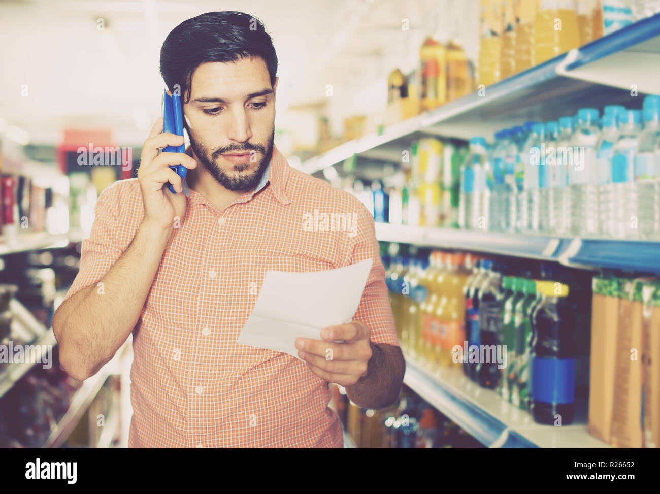happy italian man is choosing water using note list and a call to his ...