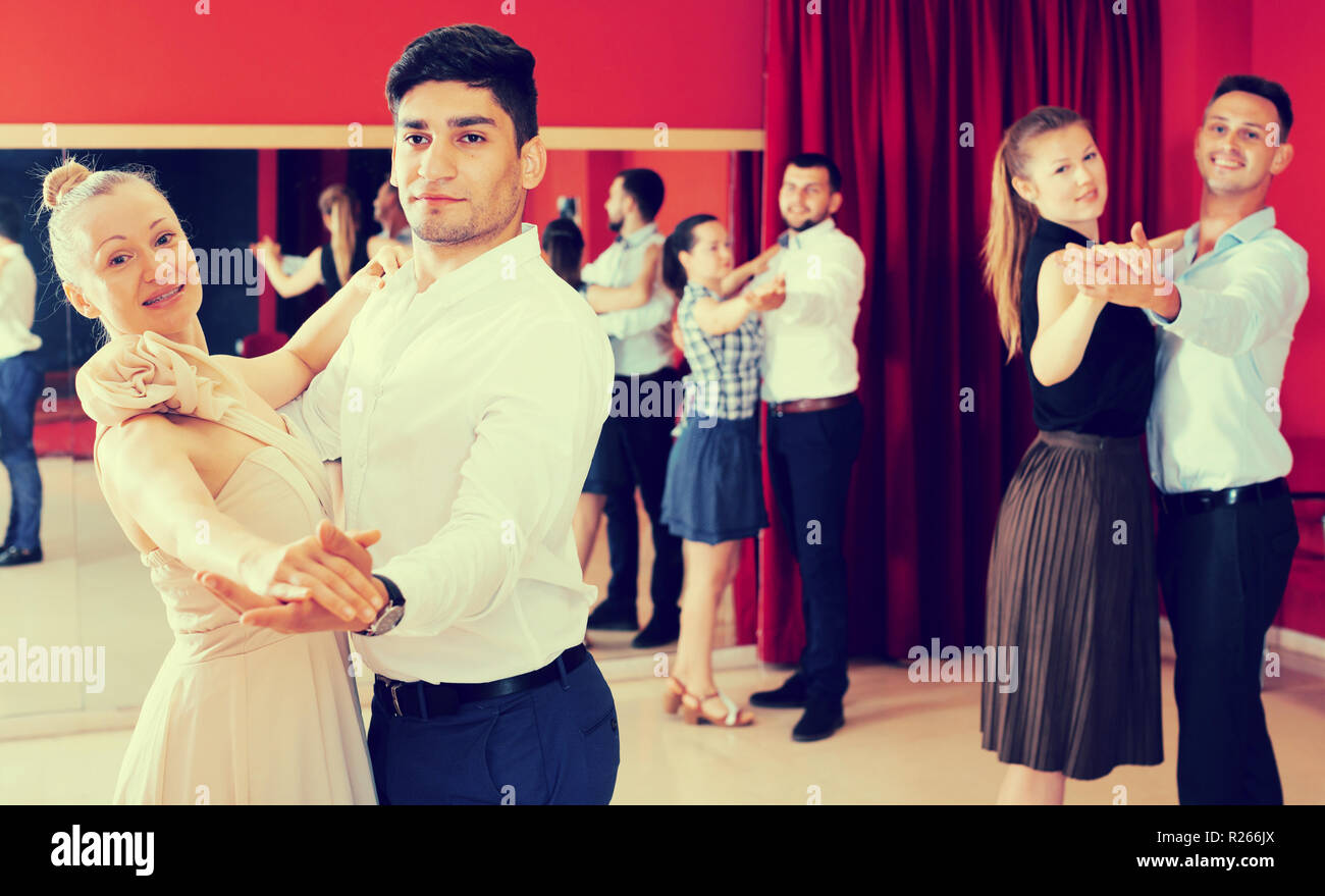Young smiling people learning to dance waltz in dancing class Stock ...