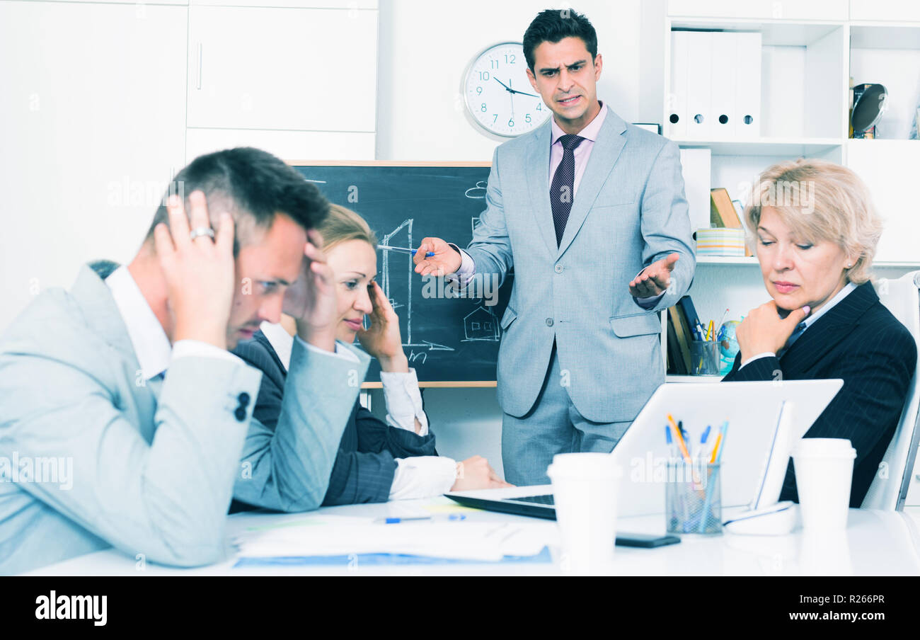 Angry boss blowing up his subordinates for mistakes in work Stock Photo ...