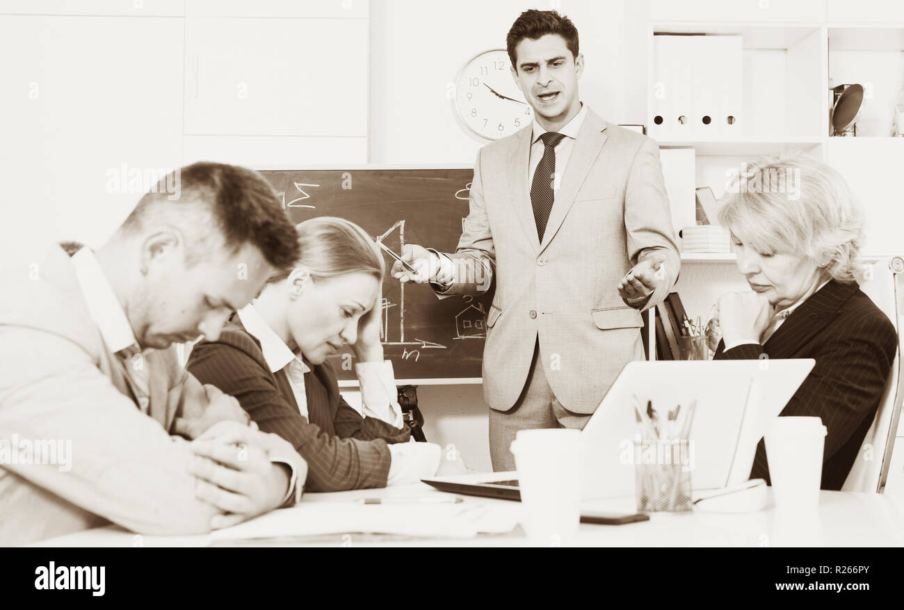 Angry boss blowing up his subordinates for mistakes in work Stock Photo ...