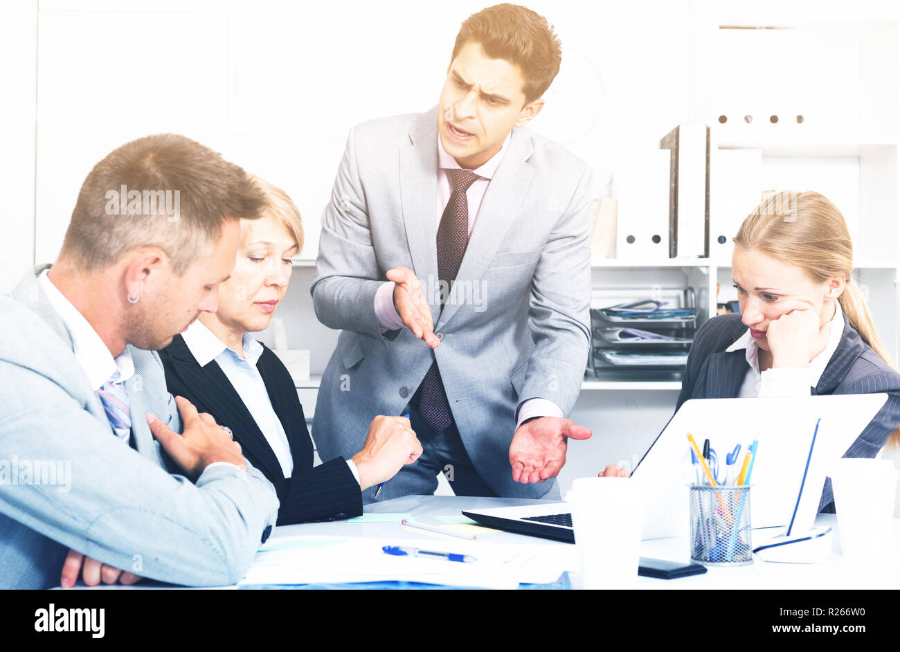 Irritated boss scolding subordinates pointing out shortcomings and ...