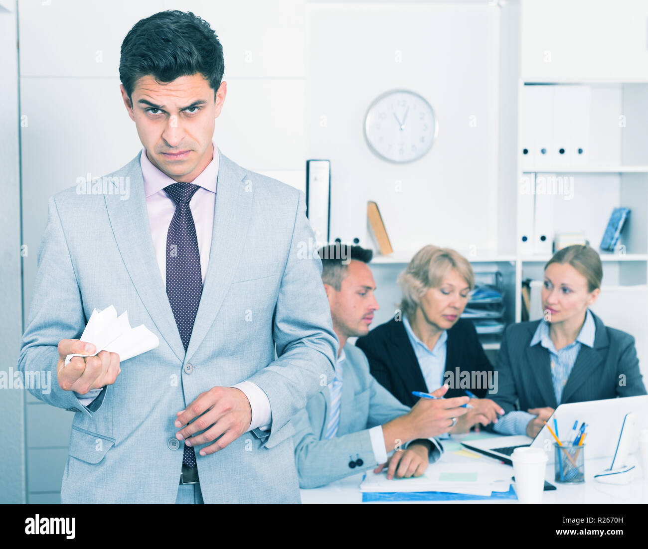 Angry manager standing in office dissatisfied with teamwork of ...
