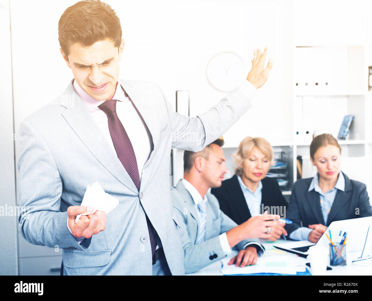 Angry manager standing in office dissatisfied with teamwork of ...