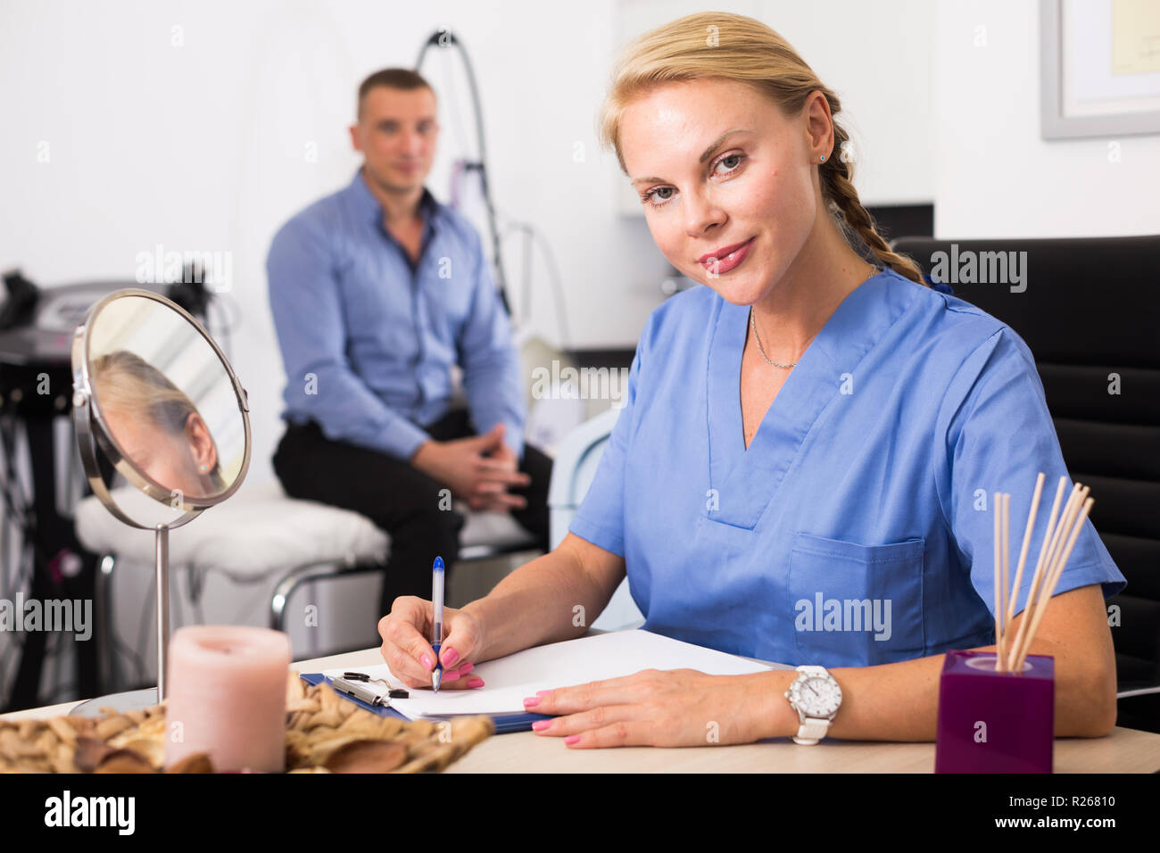 Female doctor is writing the conclusion about result of examination of ...