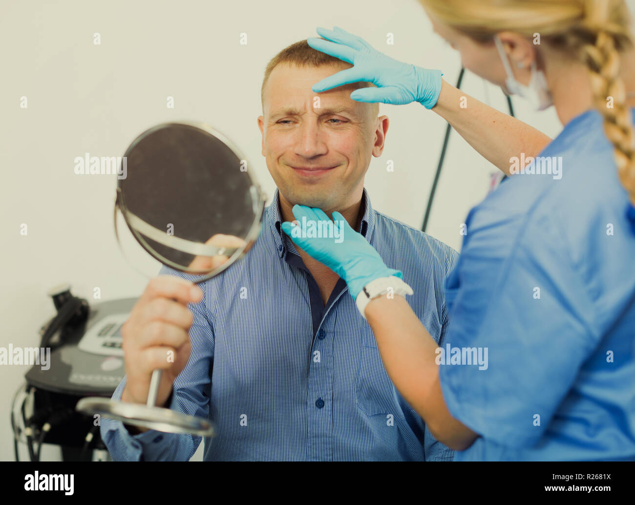 Female doctor is preparing client to procedure in cabinet Stock Photo ...