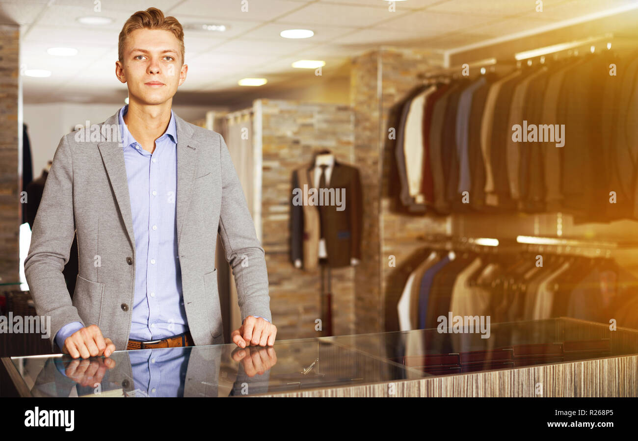 Male in business clothes seller standing in the dress shop Stock Photo ...