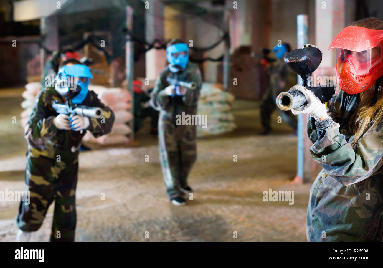 Happy cheerful smiling players are targeting in opponents from cover in ...