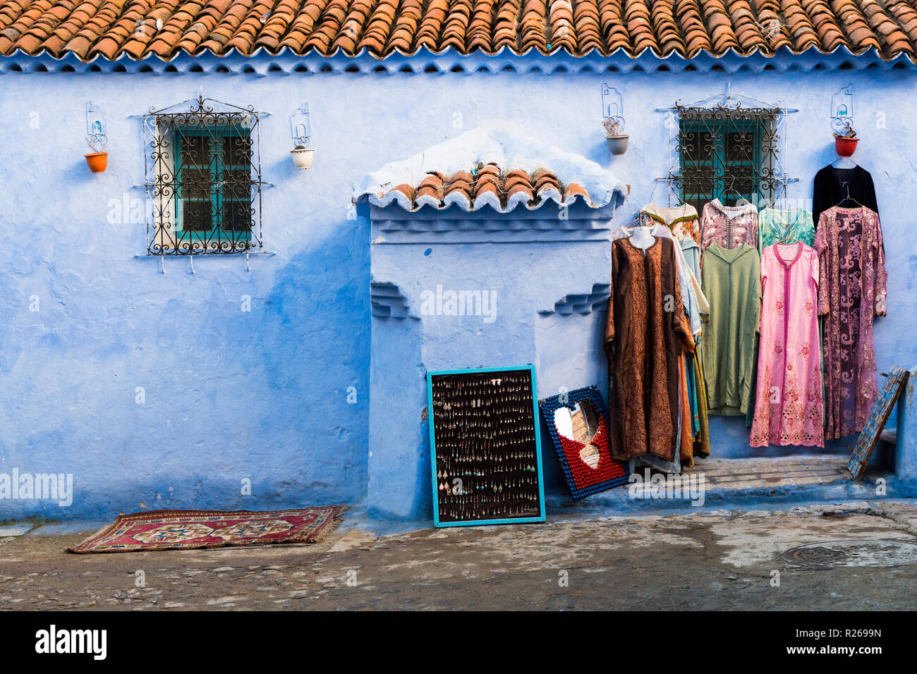 Colorful dresses in small street of Chefchaouen city in Morocco Stock ...
