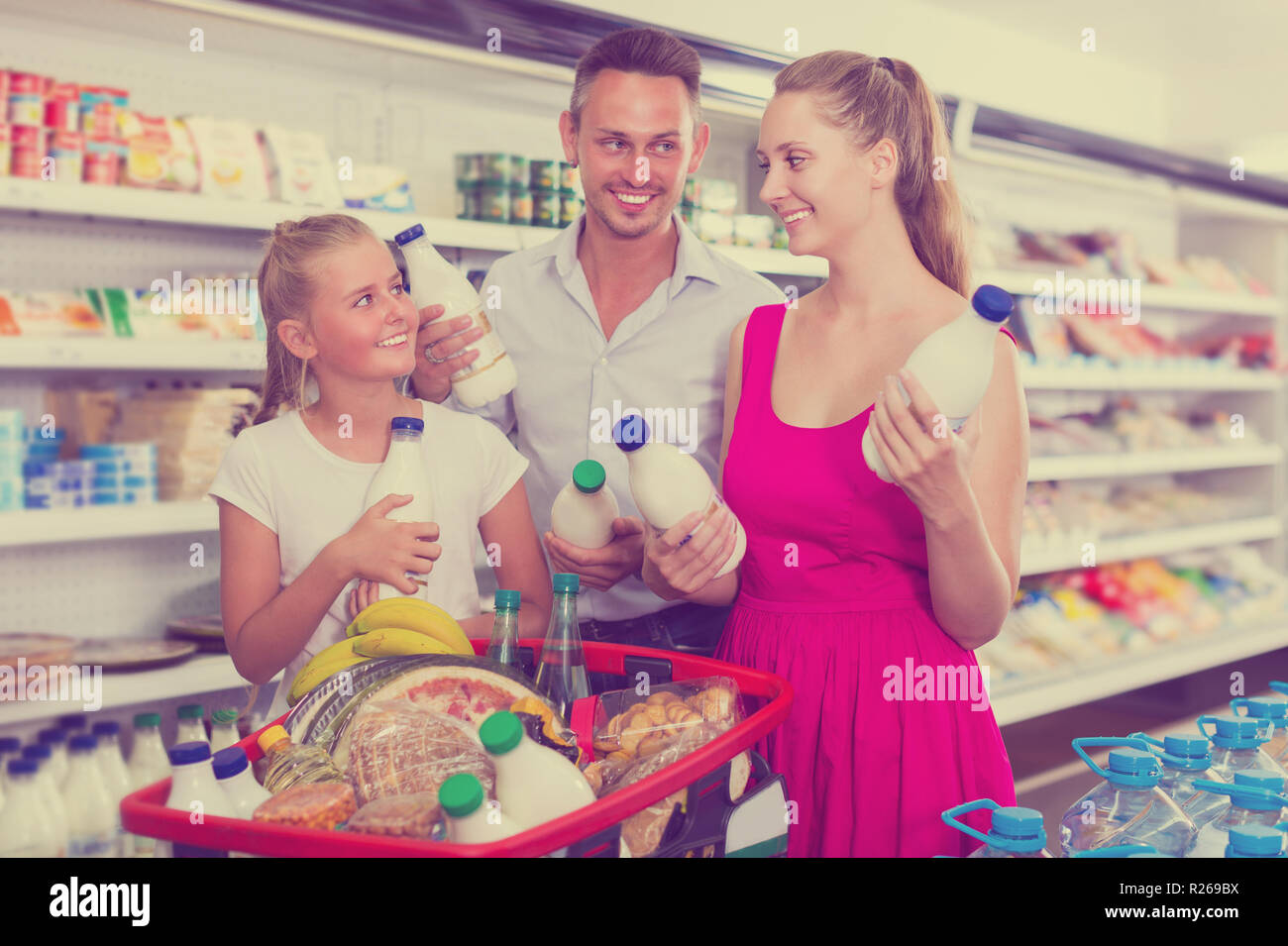 Family is selecting milk in supermarket Stock Photo - Alamy
