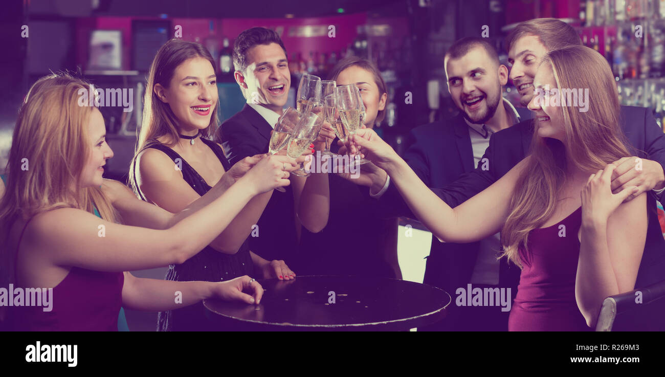 Glad colleagues dancing on corporate party with cocktails Stock Photo ...